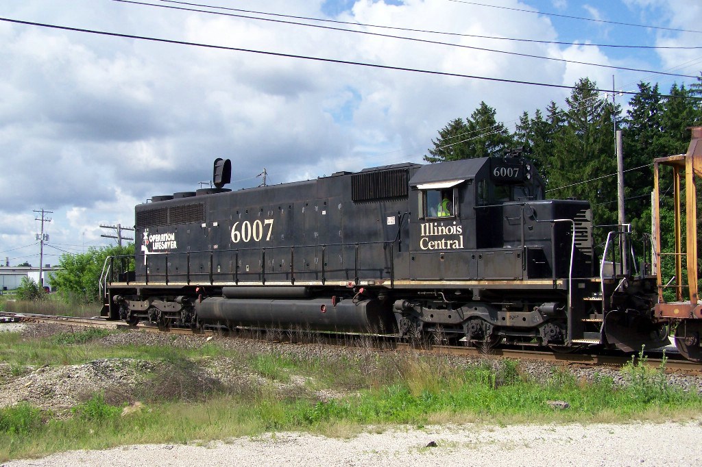 IC 6007 pulls a rock train southbound with long hood forward